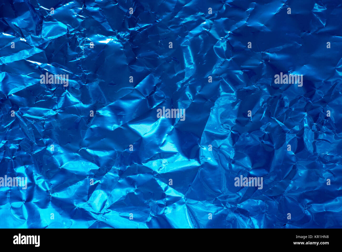 blue color folded metallic foil abstract bacgkground Stock Photo - Alamy