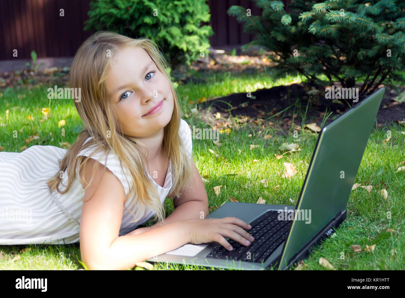 Cute girl with laptop Stock Photo - Alamy