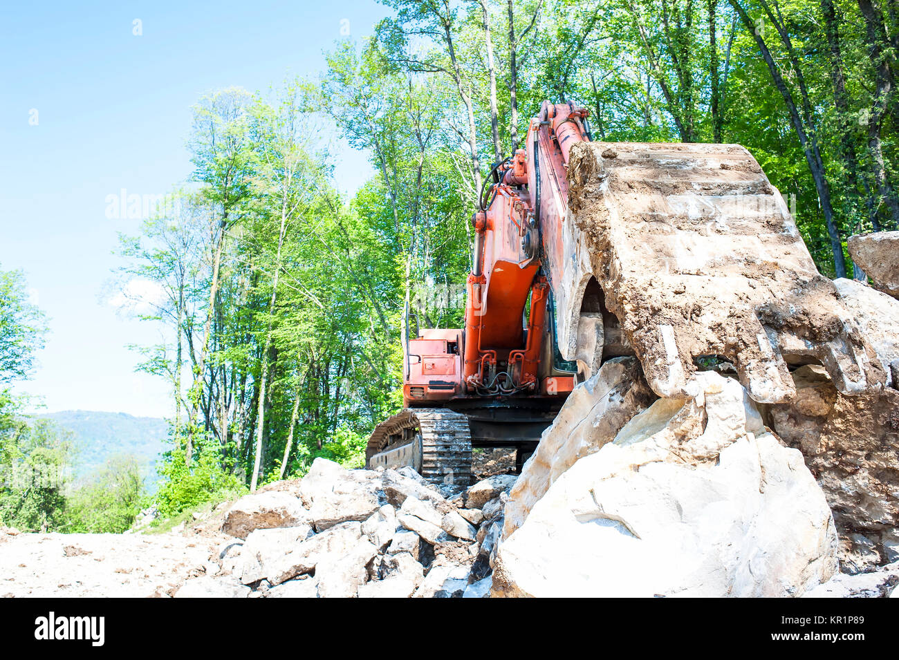 Excavator with big shovel to work with rocks Stock Photo - Alamy