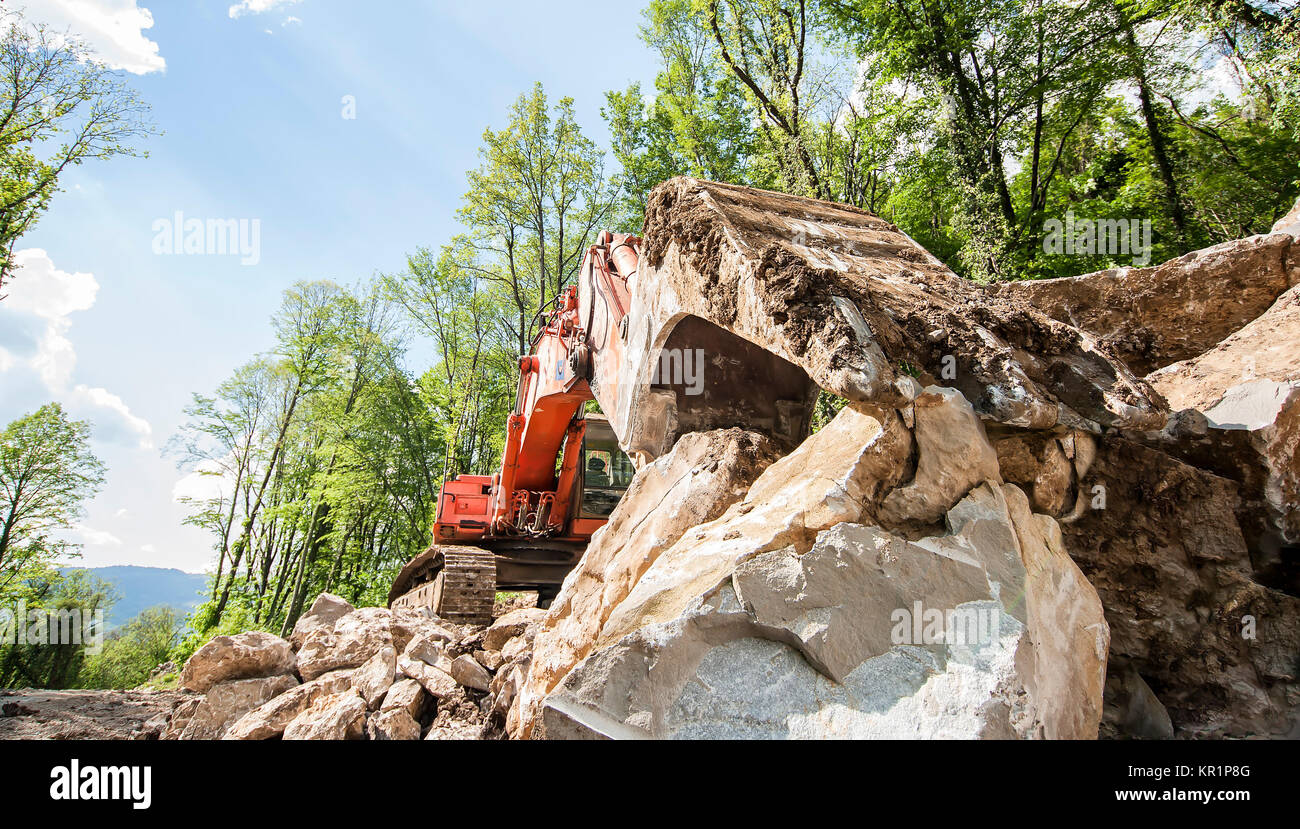 Excavator with big shovel to work with rocks Stock Photo - Alamy
