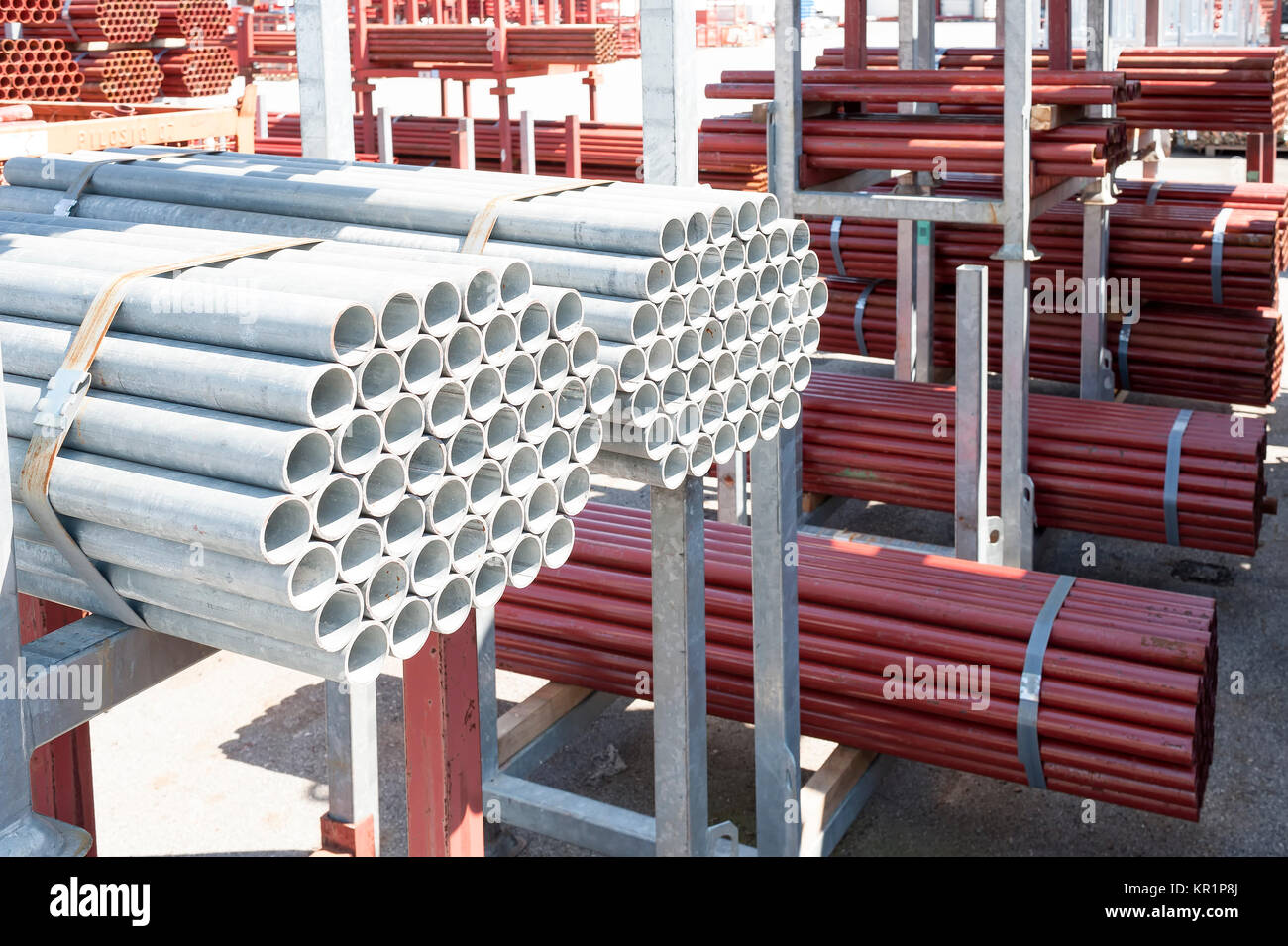 Steel Pipes bunch on the rack in warehouse Stock Photo - Alamy
