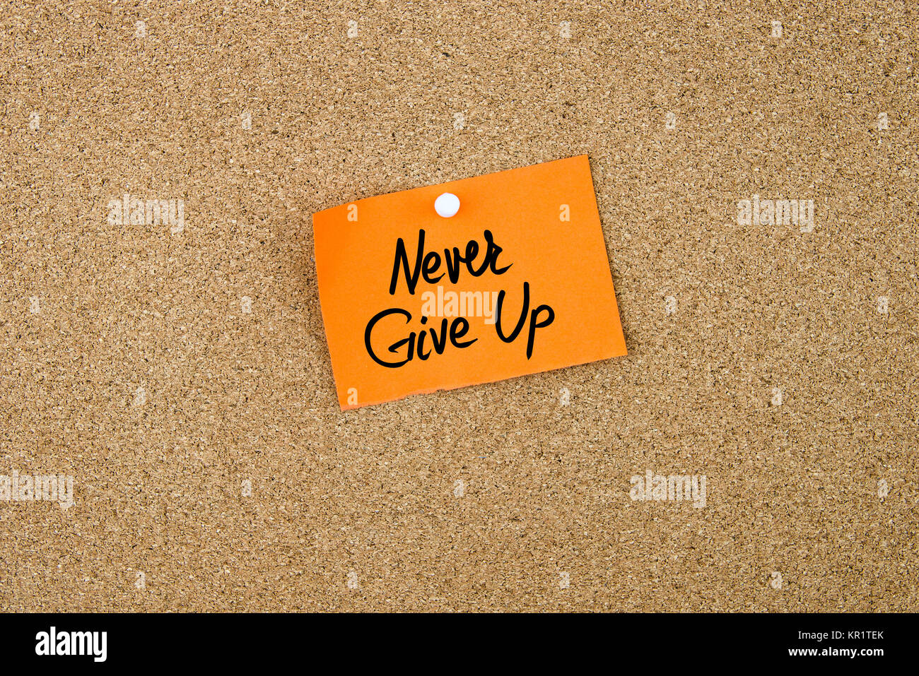Never Give Up written on orange paper note Stock Photo - Alamy