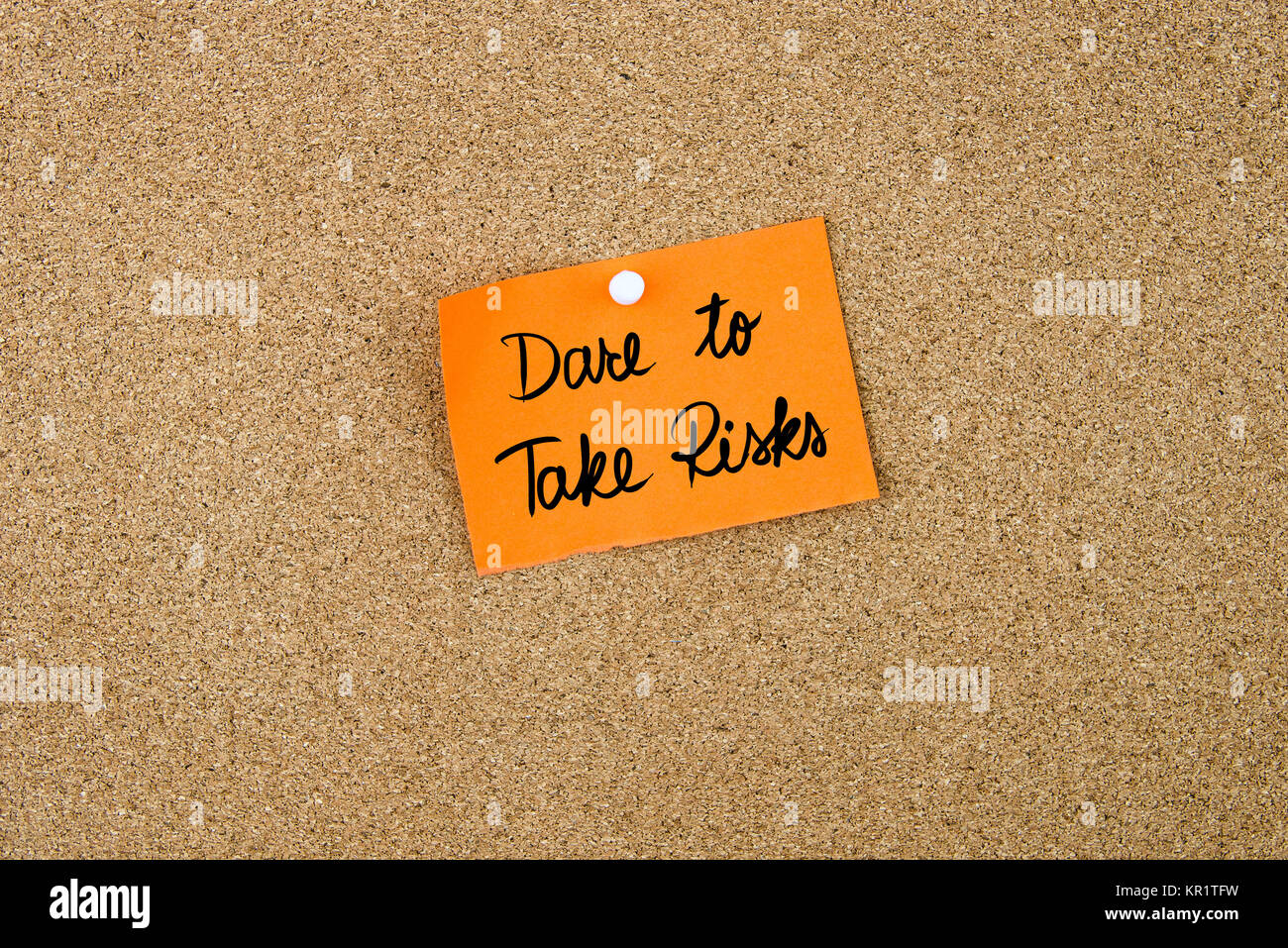 Dare To Take Risks written on orange paper note Stock Photo - Alamy