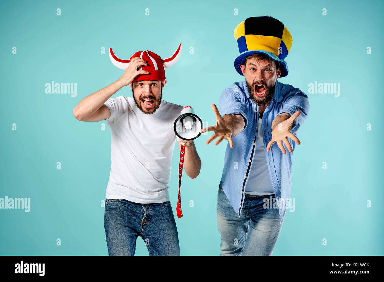The two football fans with mouthpiece over blue Stock Photo - Alamy