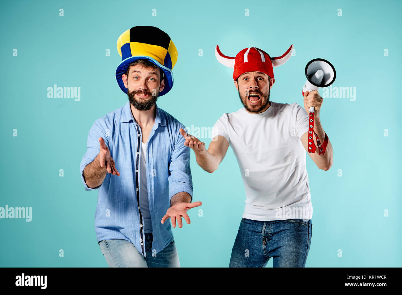 The two football fans with mouthpiece over blue Stock Photo - Alamy