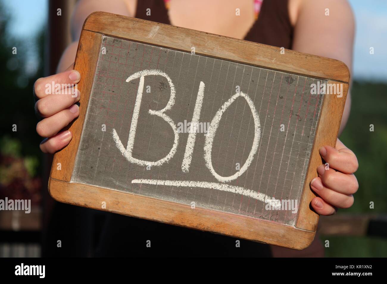 BIO written with chalk on slate shown by young female Stock Photo - Alamy