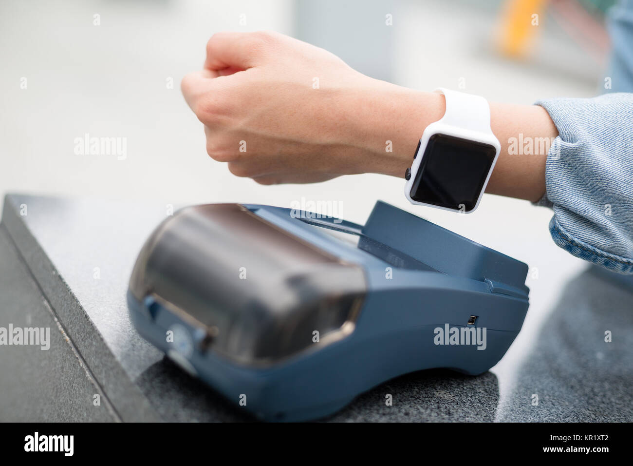 Woman using her smart watch to pay Stock Photo - Alamy
