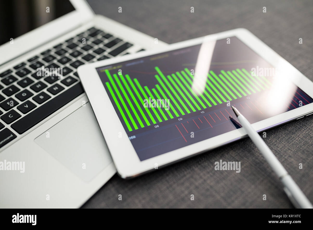 Tablet pc showing charts Stock Photo - Alamy