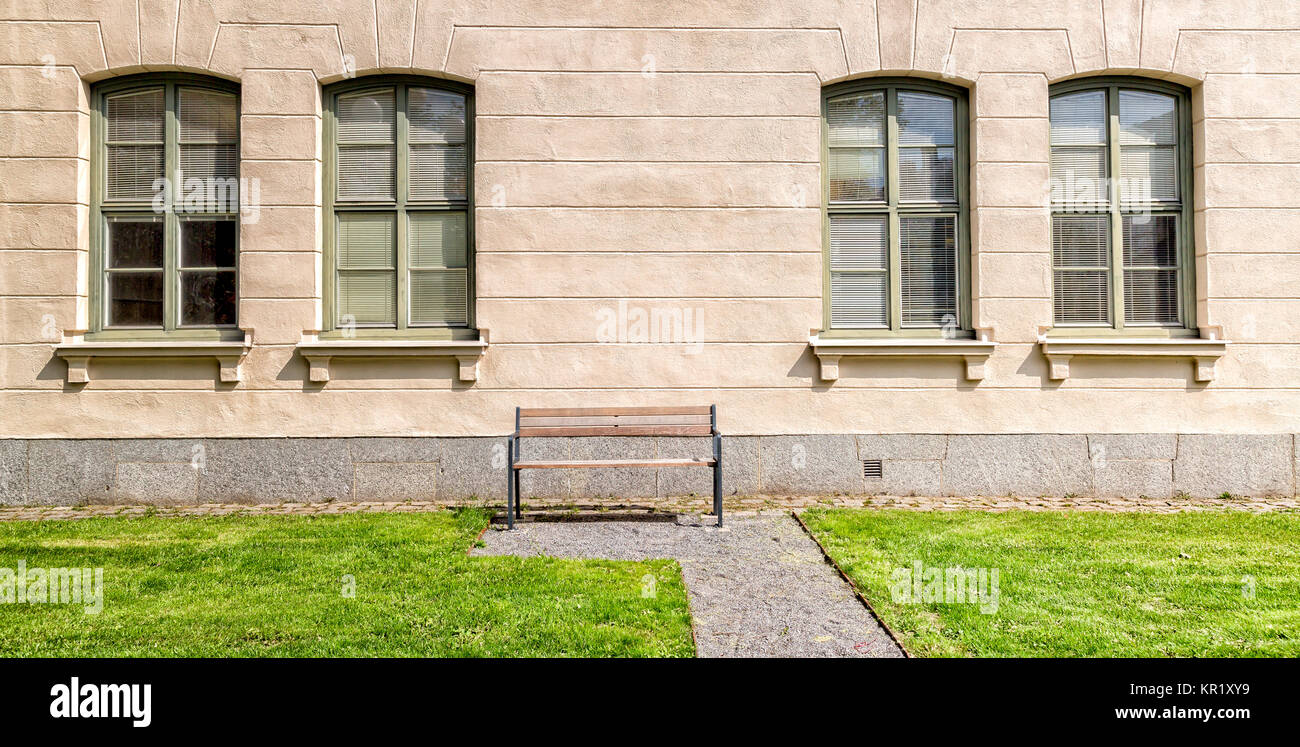 Bench in front of Windows Stock Photo - Alamy