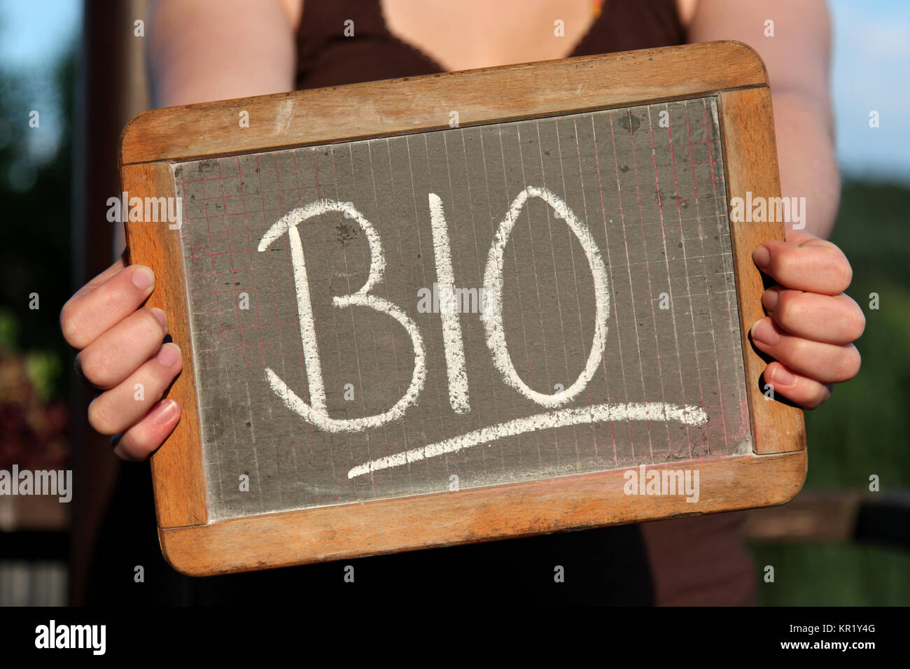 BIO written with chalk on slate shown by young female Stock Photo - Alamy