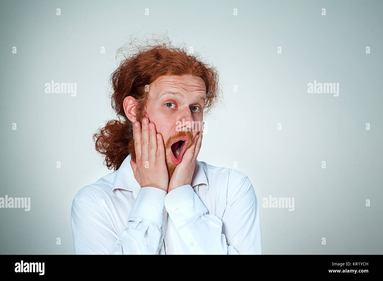 Portrait of young man with shocked facial expression Stock Photo - Alamy