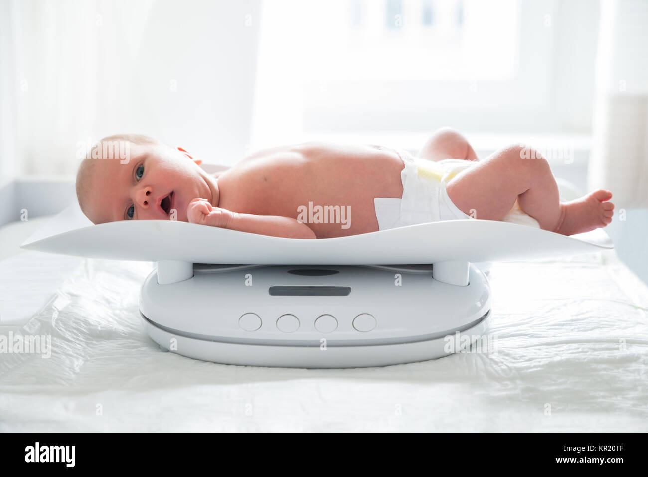 Weighting Baby Girl On Scale Stock Photo - Alamy