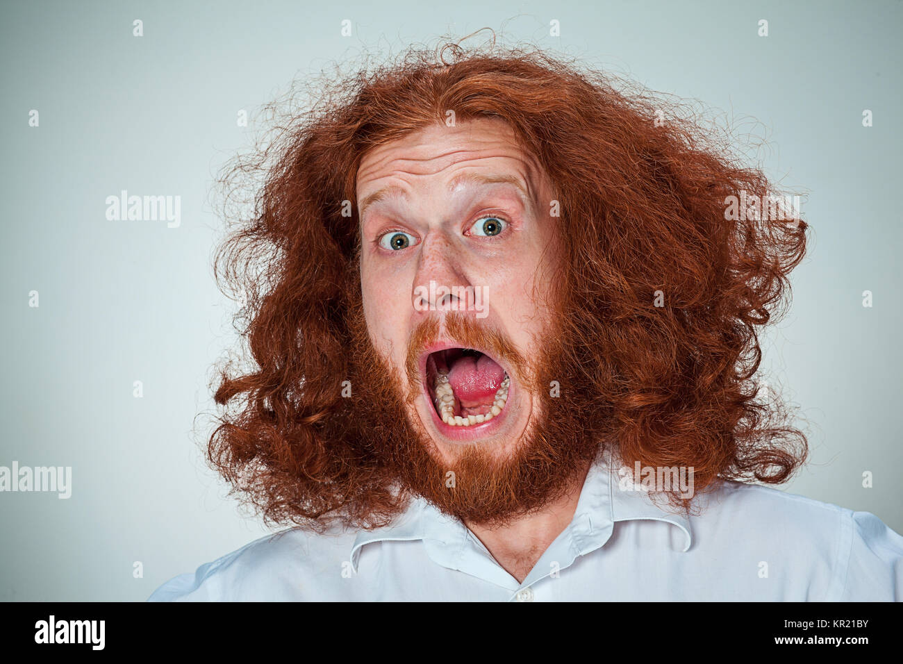 Portrait of young man with shocked facial expression Stock Photo - Alamy