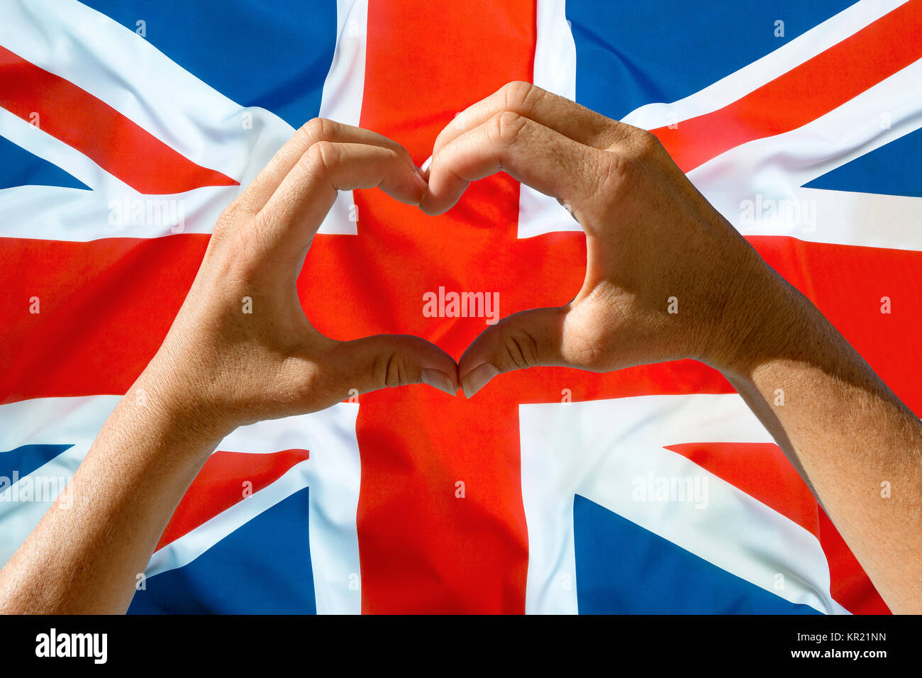 Female hands heart symbol with UK flag in background Stock Photo - Alamy