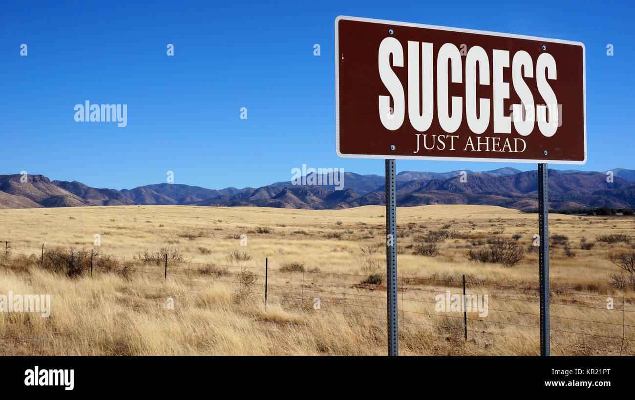 Success Just Ahead brown road sign Stock Photo - Alamy