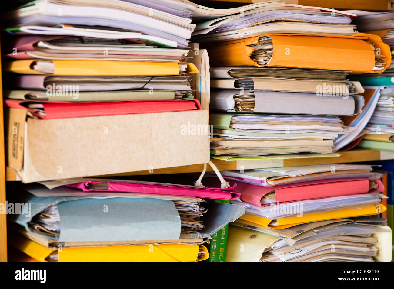 Two stacks of colorful folders and documents at home Stock Photo - Alamy