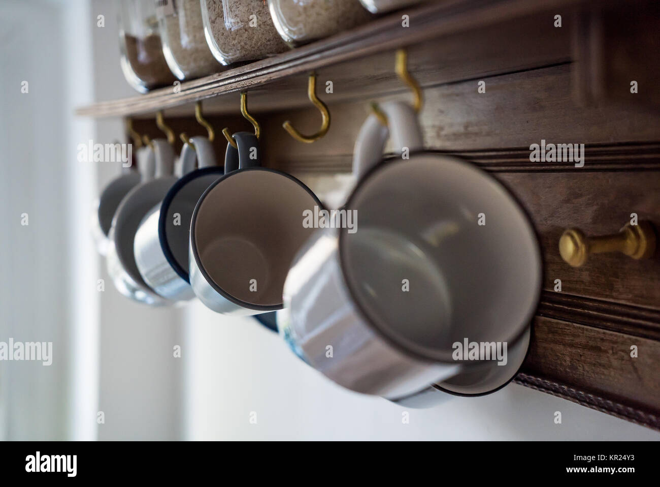 cups hanging in kitchen on wooden wall Stock Photo - Alamy
