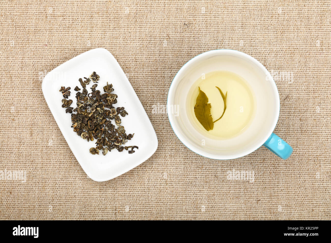 Big empty cup of green tea with leaf on bottom and white plate with ...