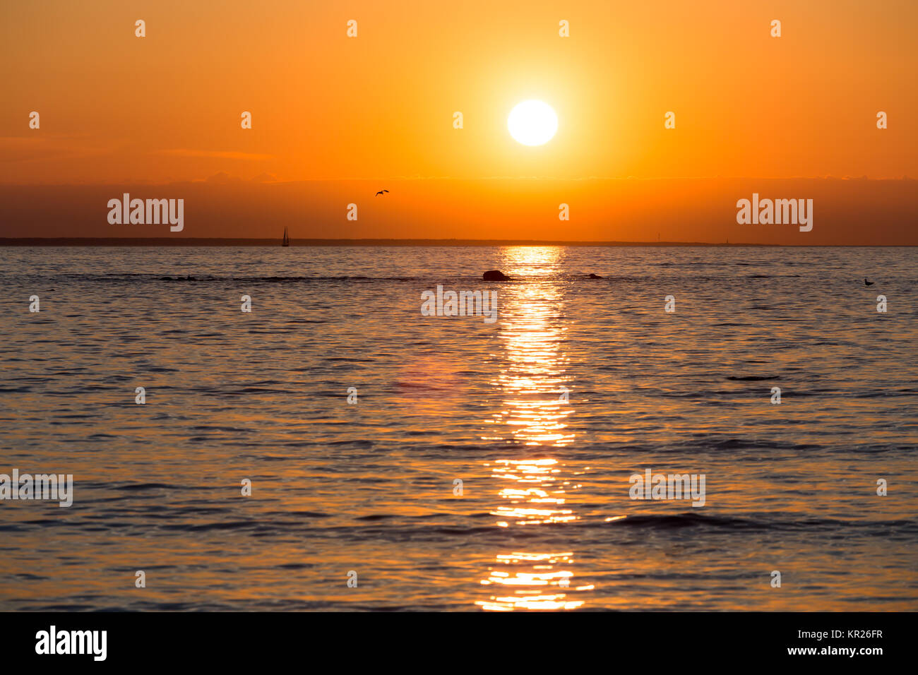 Bright sky and water at sunset Stock Photo - Alamy