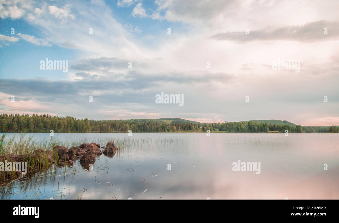 Lake with Rocks and Forest Stock Photo - Alamy
