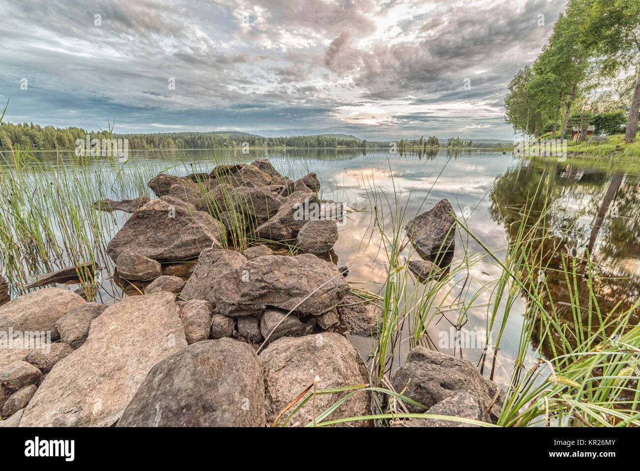 Lake with Rocks and Forest Stock Photo - Alamy