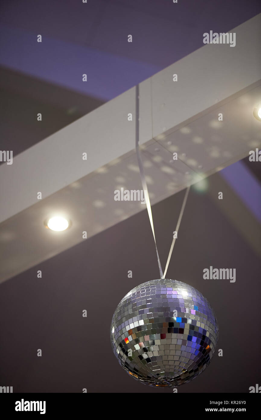 The high white ceiling with exposed beams. Decorated with disco balls ...
