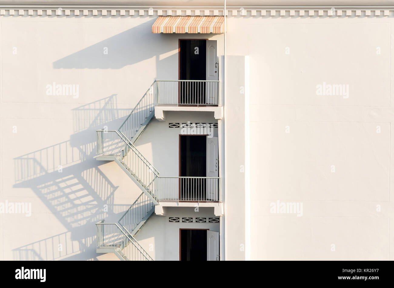 fire escape with afternoon shadows on exterior wall Stock Photo - Alamy