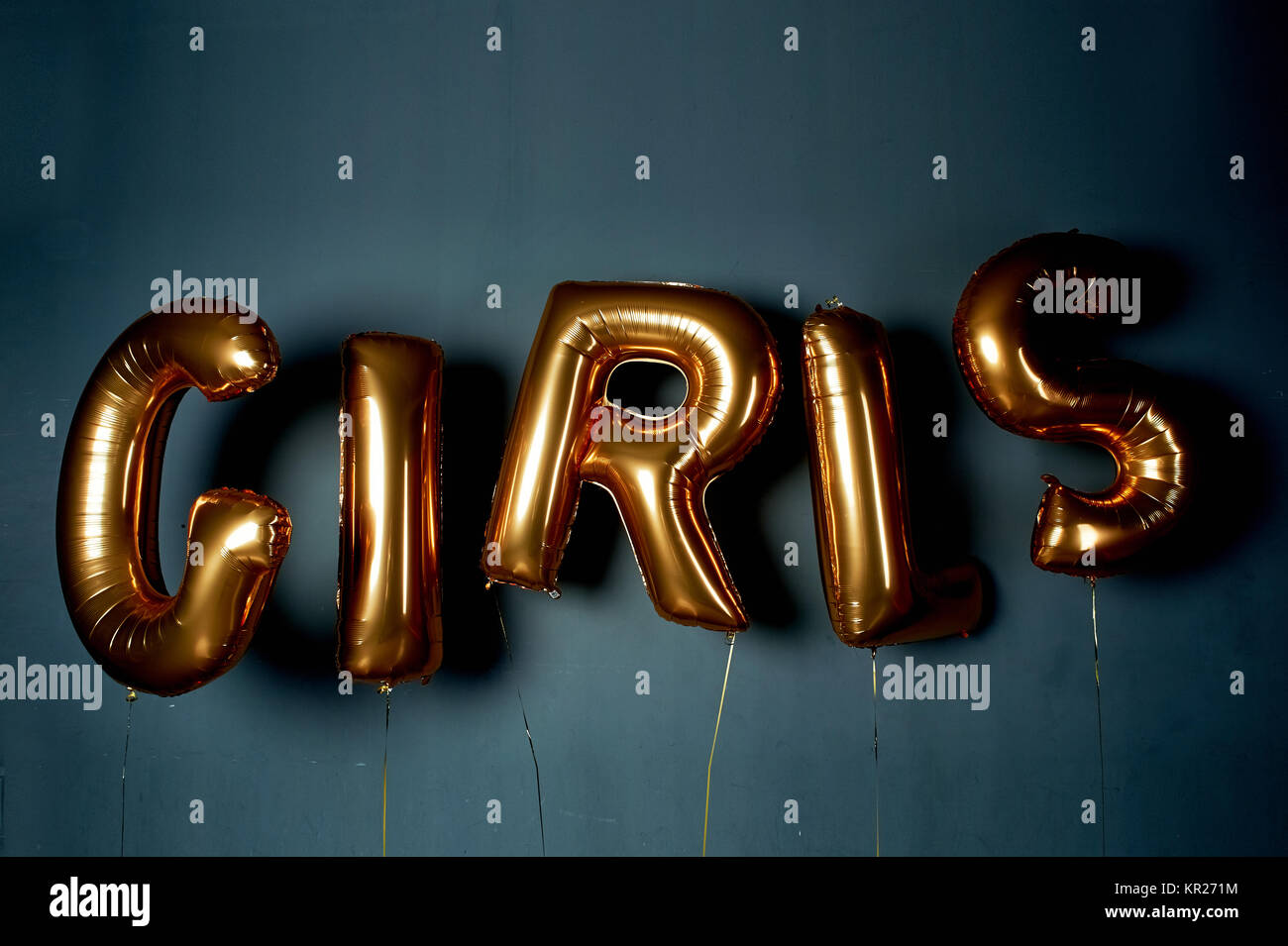 Golden balloons in the form of letters. The word girls. The atmosphere ...
