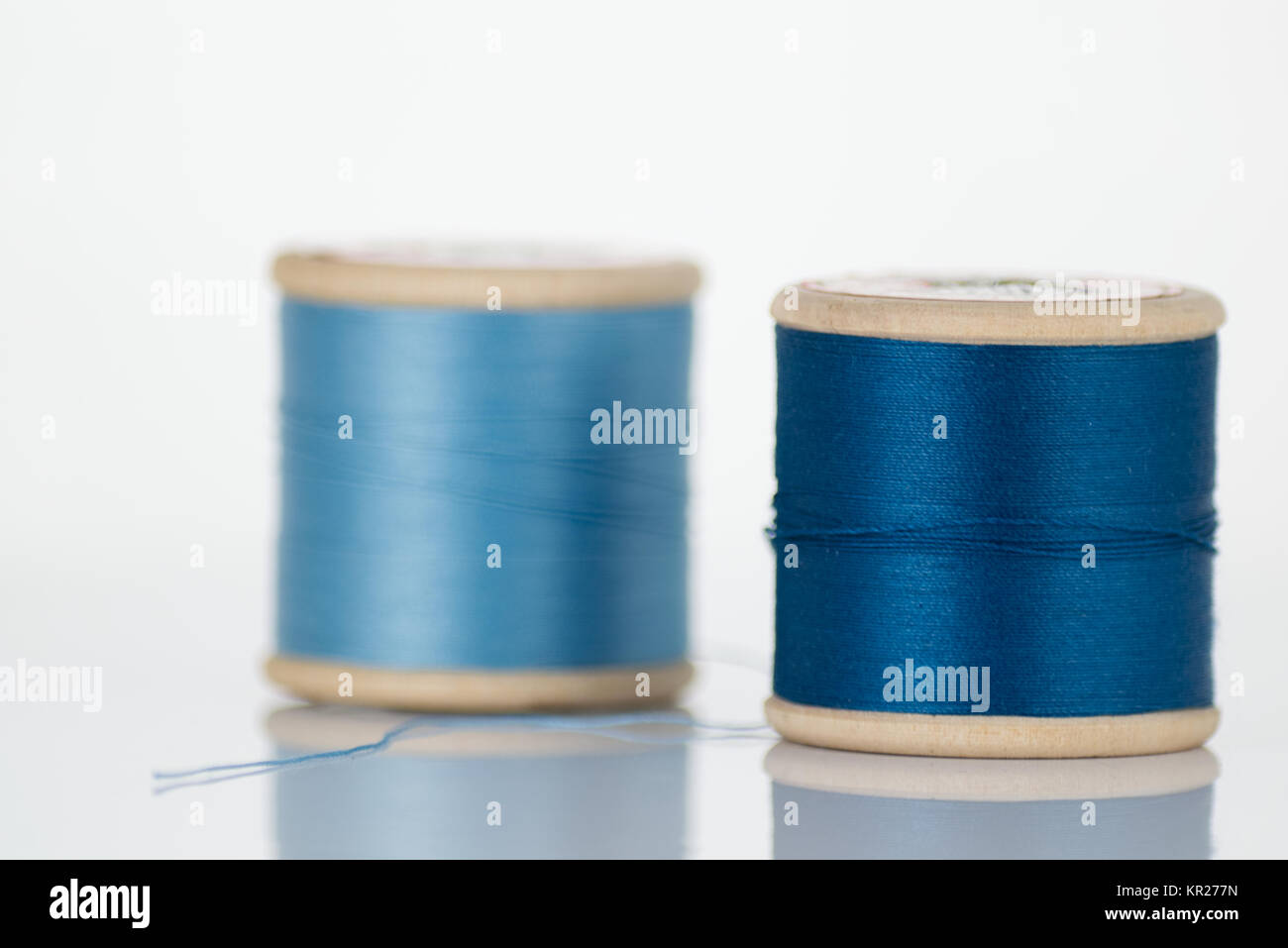 Cotton reels in shades of blue isolated on a white background. Sewing ...