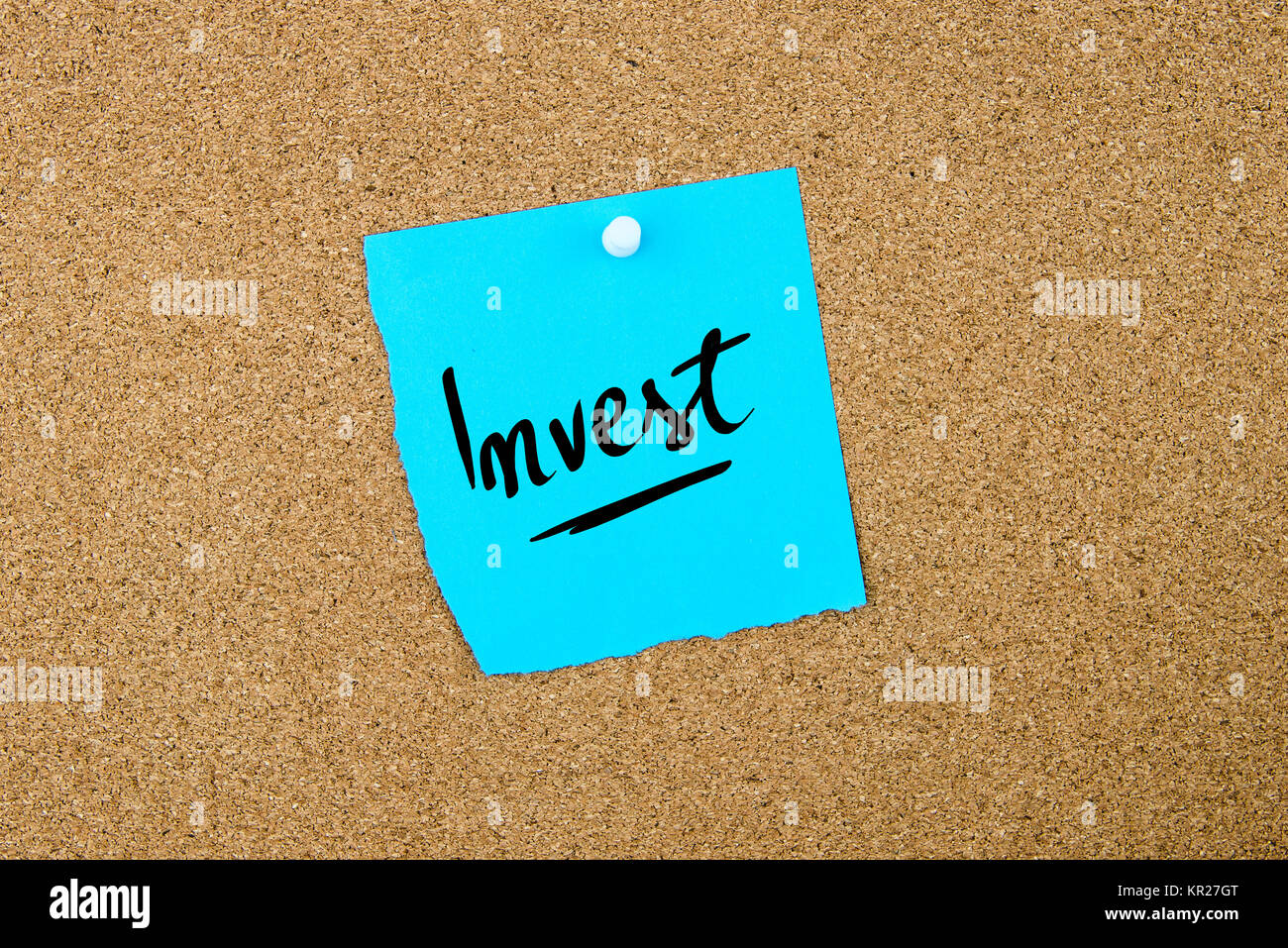 Invest written on blue paper note Stock Photo - Alamy