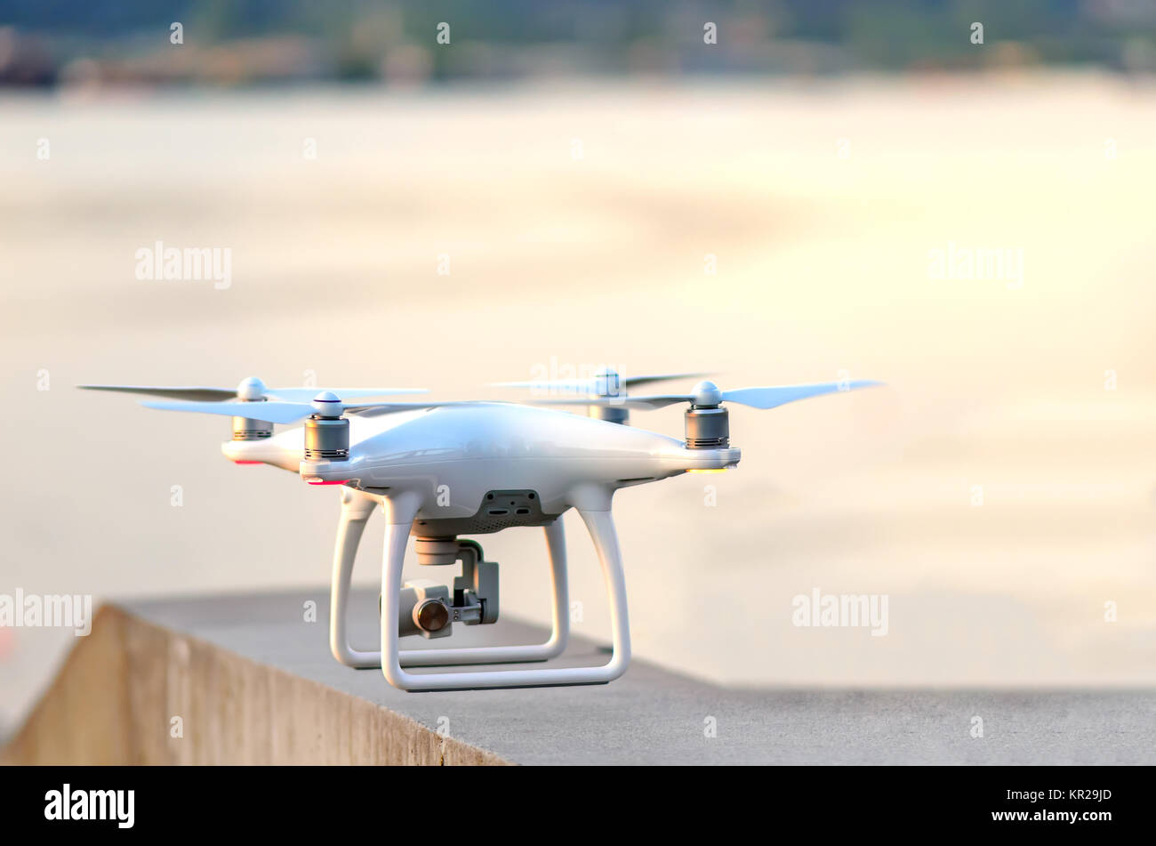 flying white drones with propellers and reflection, against the blue ...