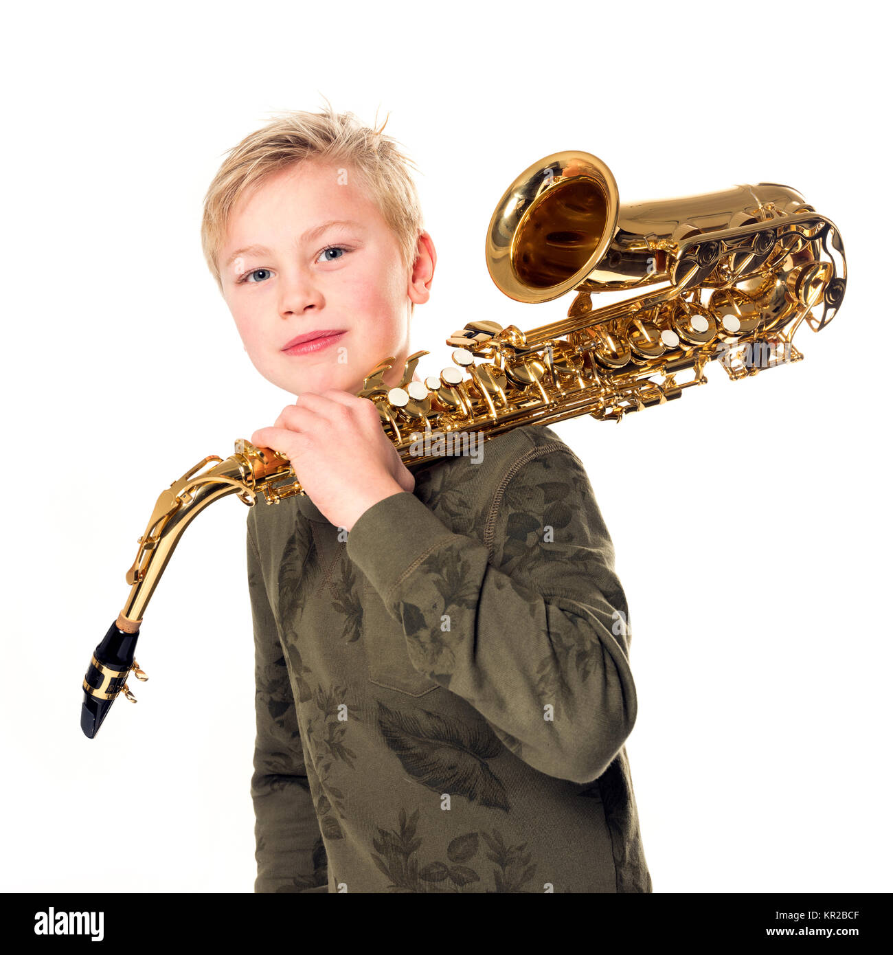 young blond boy and saxophone in studio against white background Stock ...