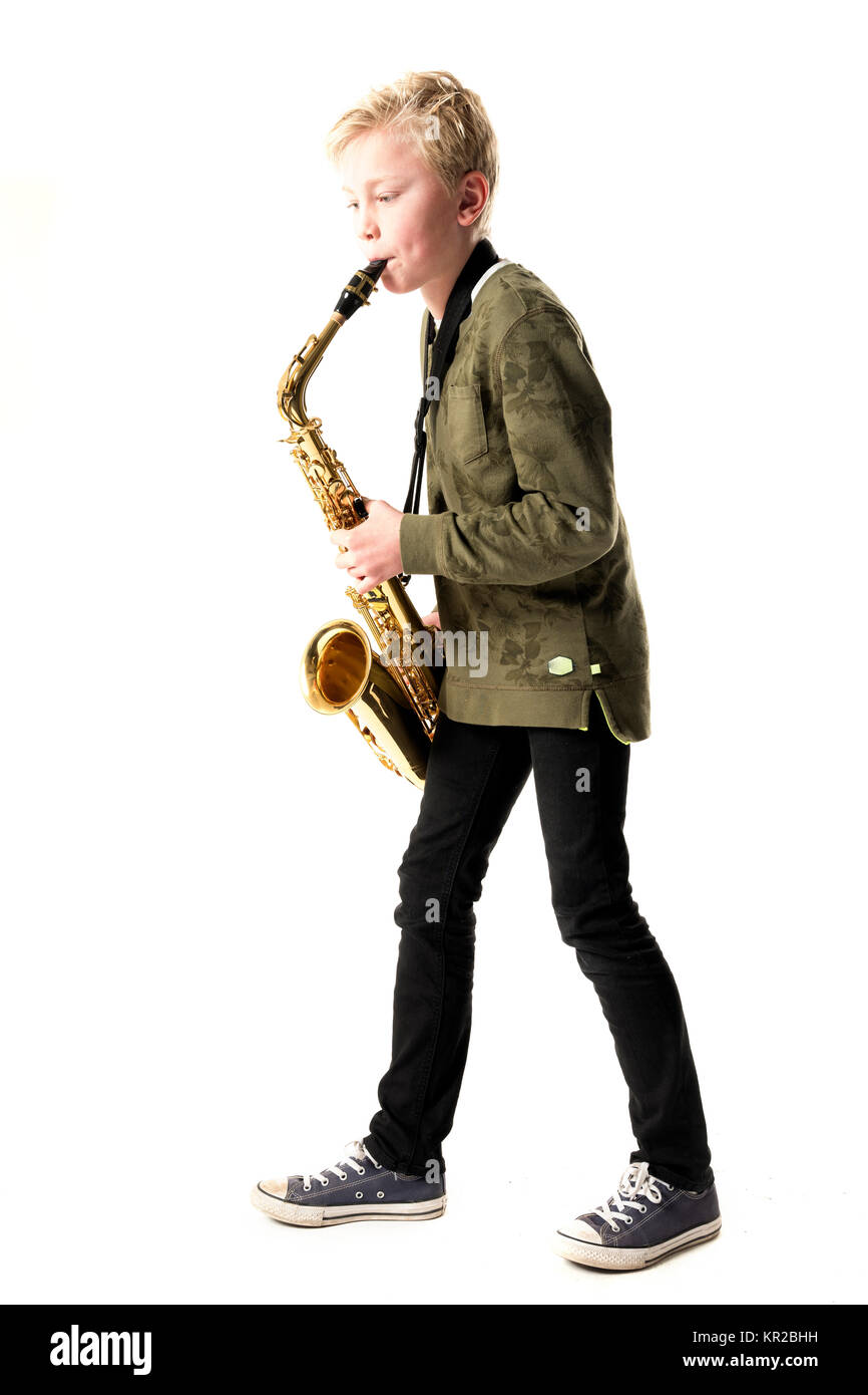 young blond boy and saxophone in studio against white background Stock ...