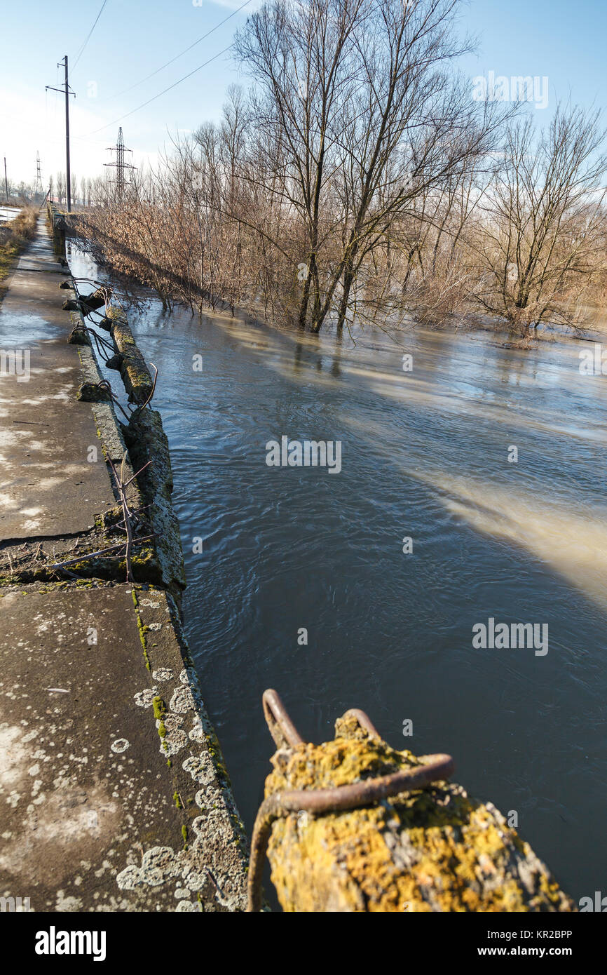 Damaged railings of the bridge across the river. Flooding on the river ...