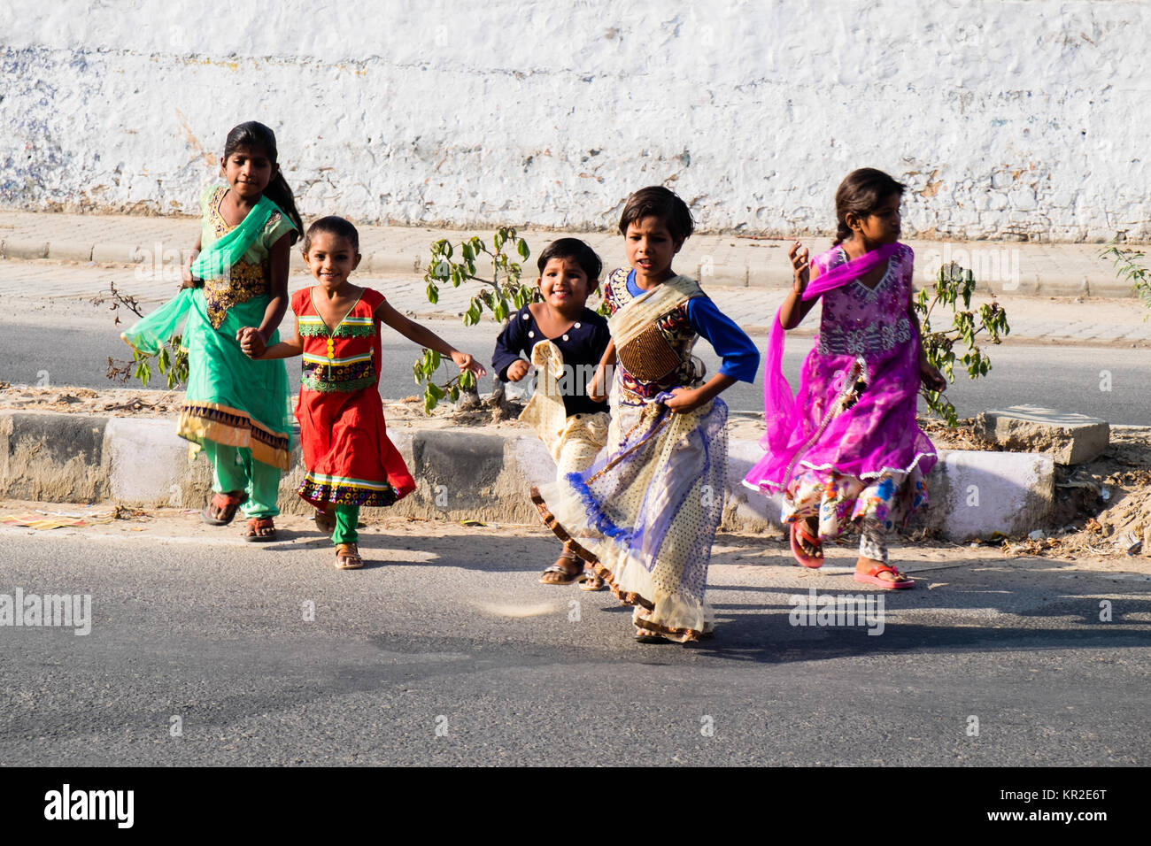 Children dressed to celebrate Diwali running to Brahma Lake, Pushkar ...