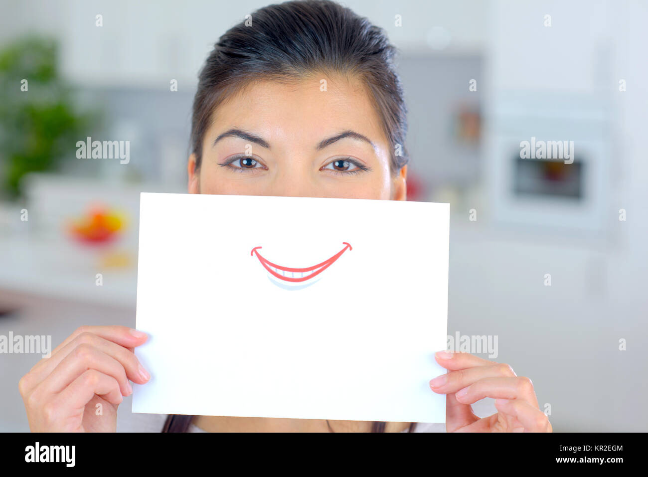 Brunette girl laughing covering mouth hi-res stock photography and ...