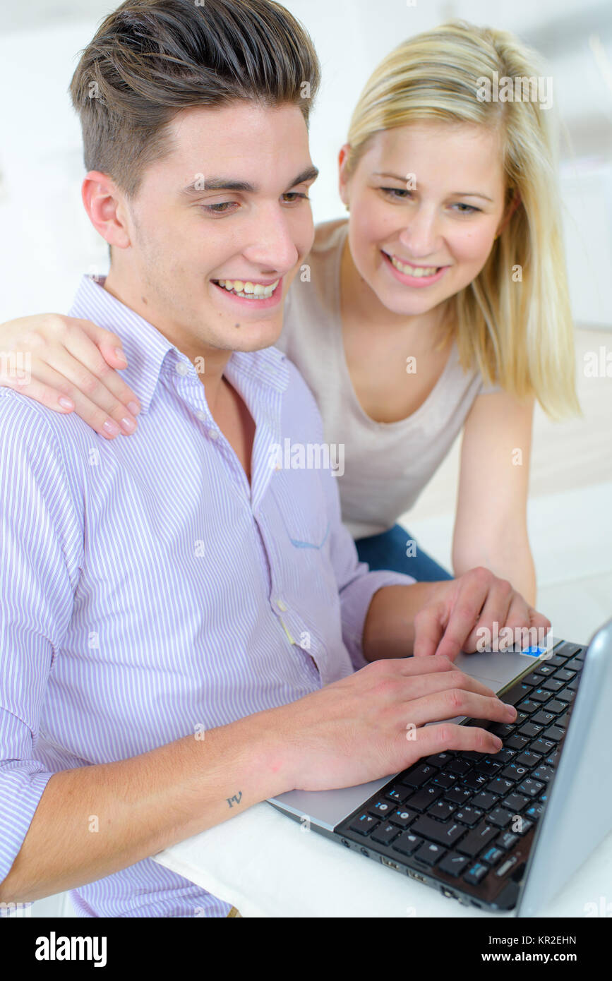 Delighted couple using laptop hi-res stock photography and images - Alamy