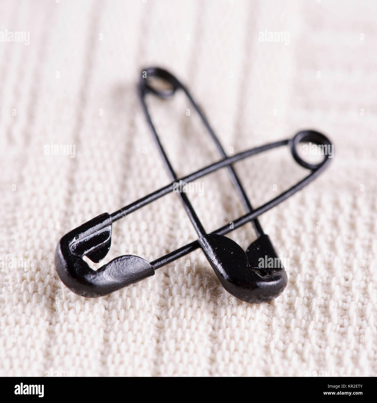 Safety pins chained Stock Photo - Alamy