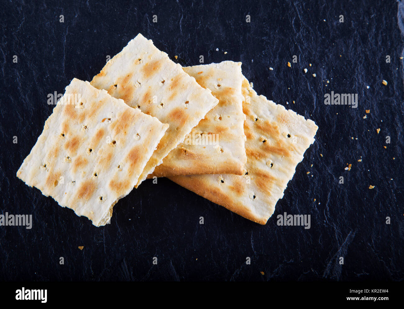 Crackers over black stone background Stock Photo - Alamy