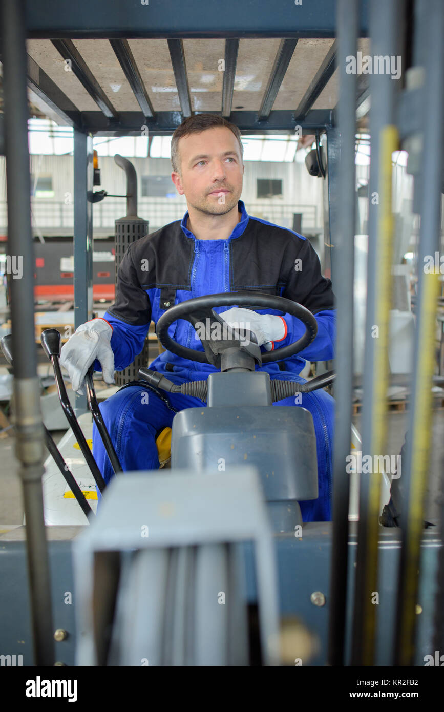 man driving a forklift Stock Photo - Alamy