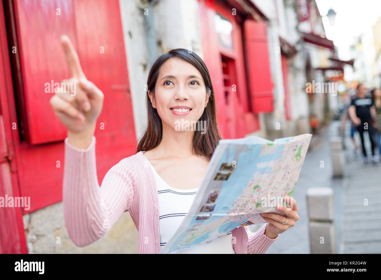 Woman finding destination on city map Stock Photo - Alamy