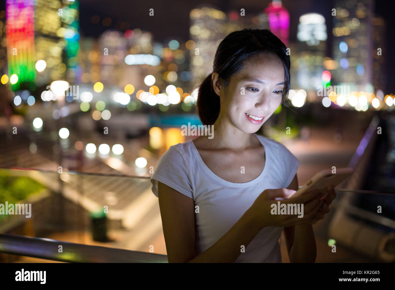 Woman use of mobile phone at night Stock Photo - Alamy