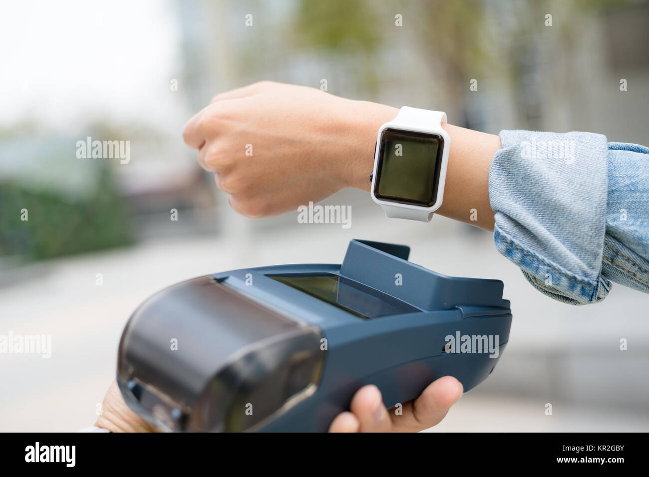 Customer pay by smart watch Stock Photo - Alamy