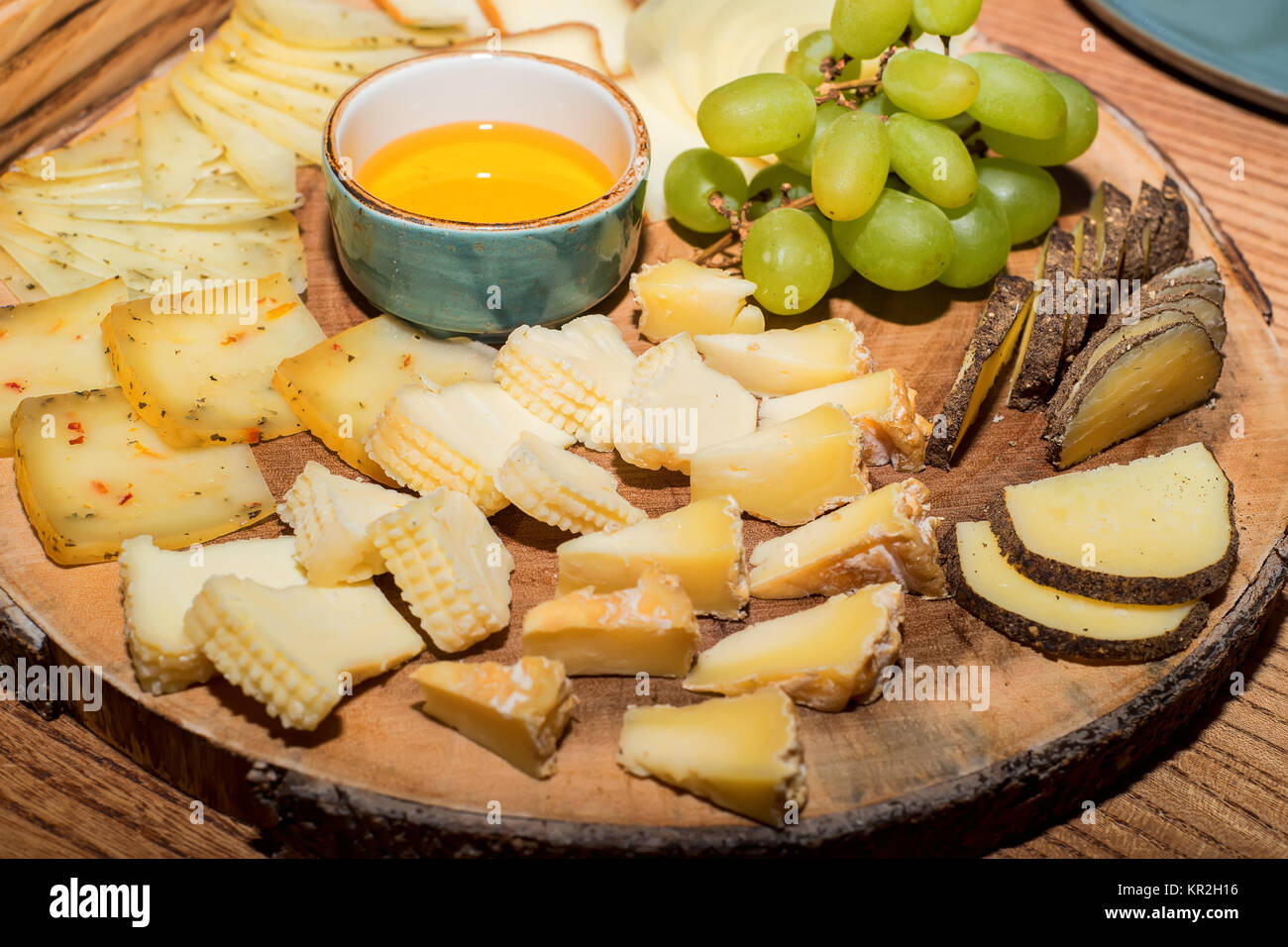 Cheese slices and pieces on plate Stock Photo - Alamy