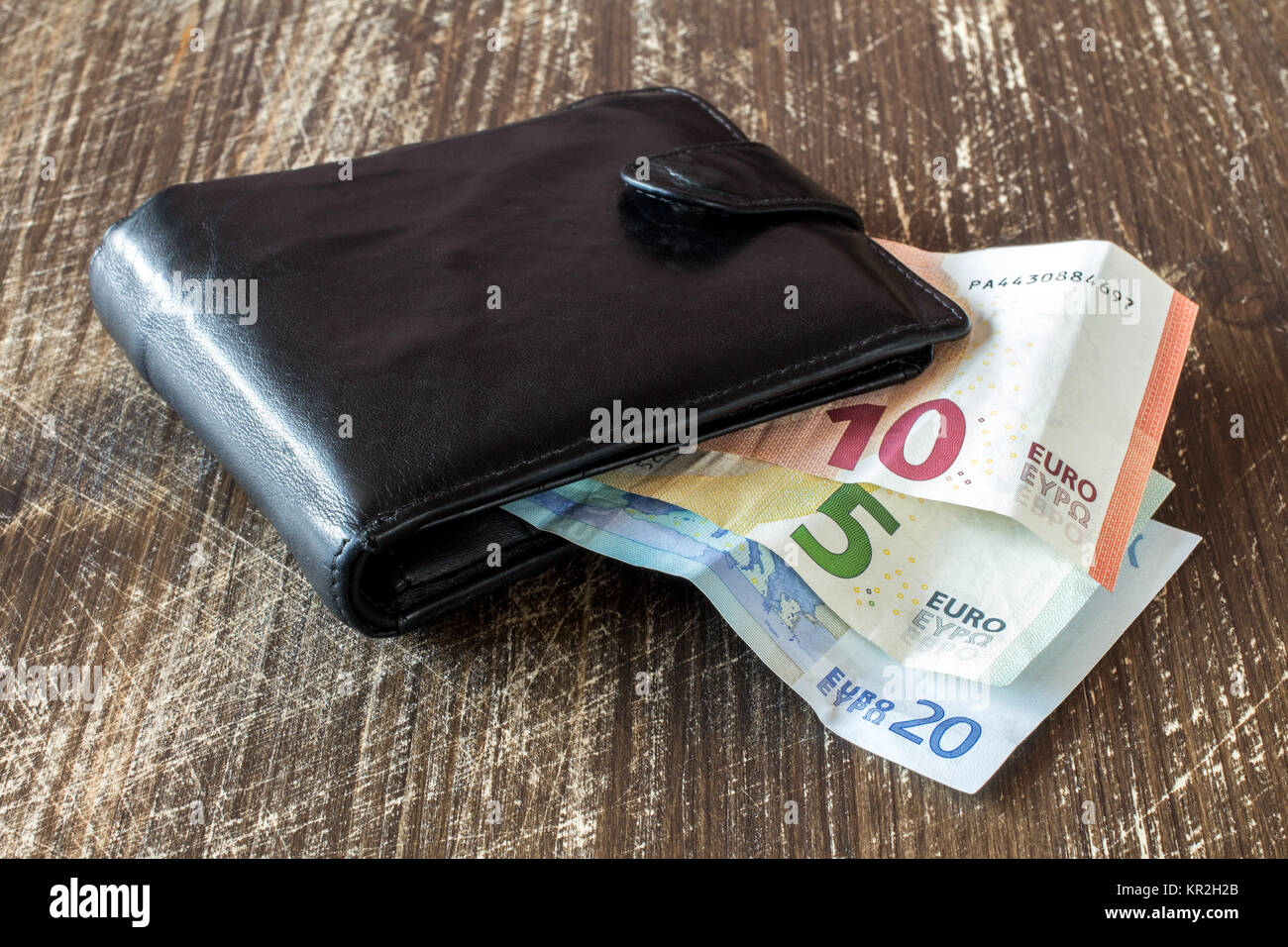 Black leather wallet with euro currency Stock Photo - Alamy
