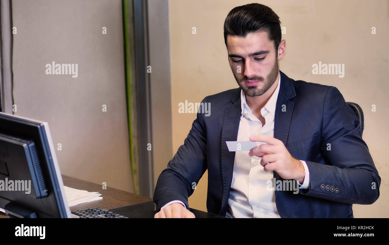 Businessman holding business card Stock Photo - Alamy