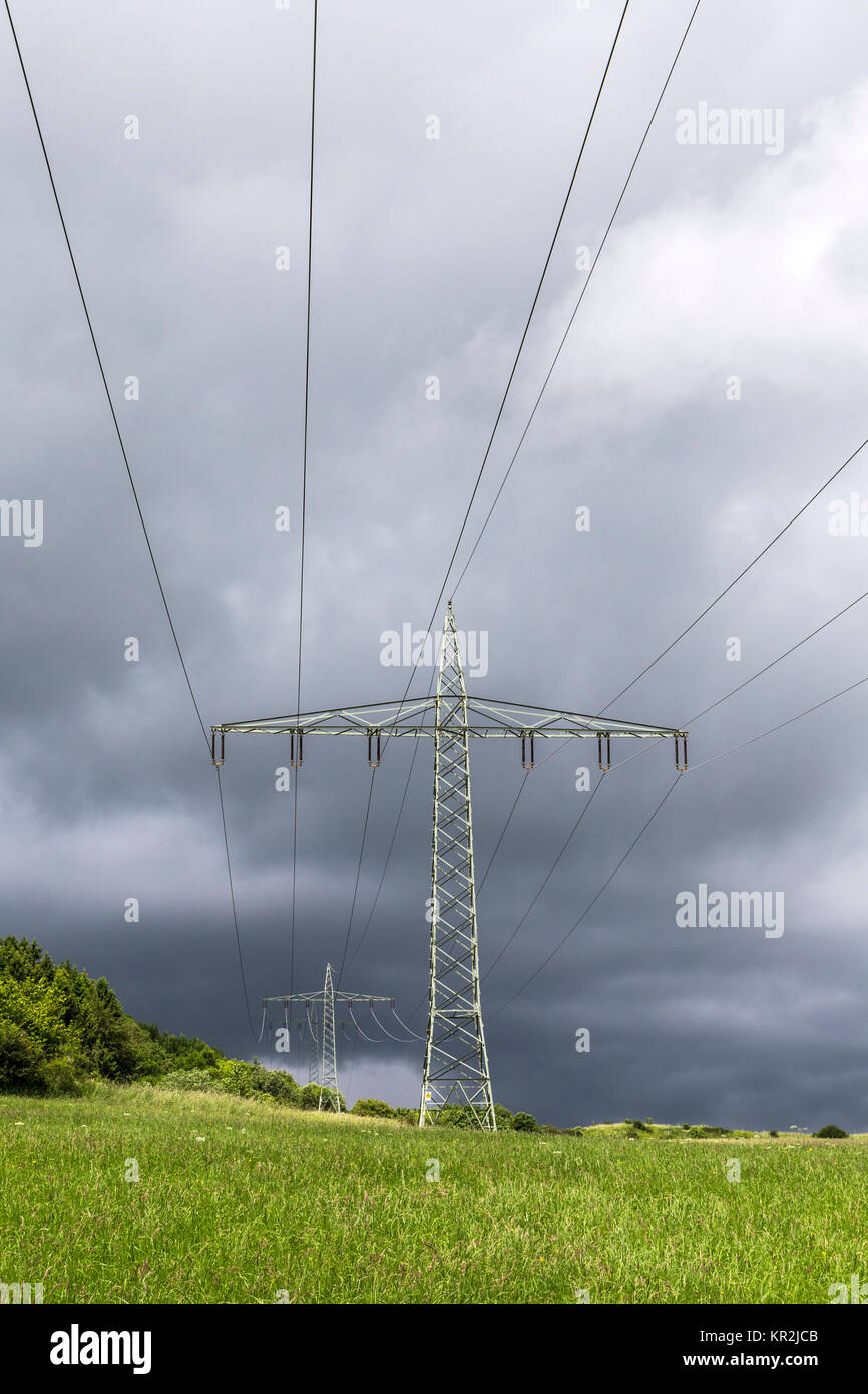 electric pylon with power lines and storm clouds above Stock Photo - Alamy