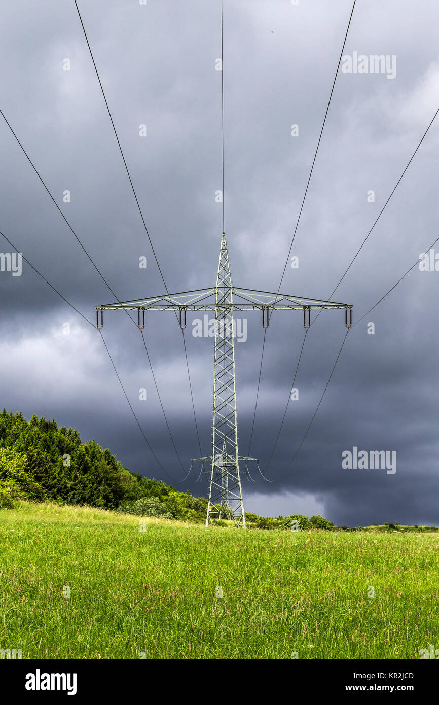 electric pylon with power lines and storm clouds above Stock Photo - Alamy