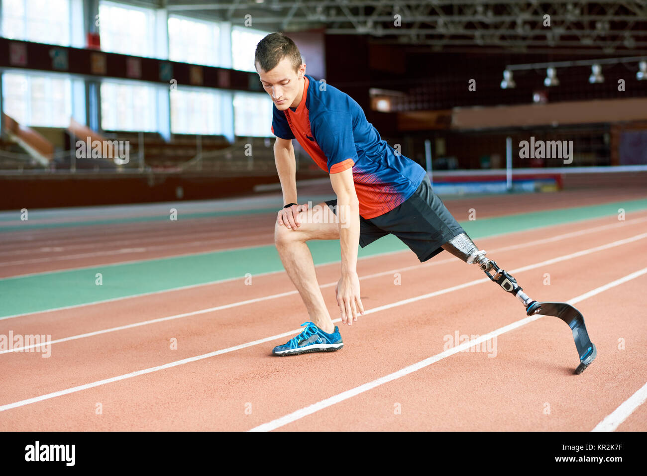 Handicapped Runner Stretching in Stadium Stock Photo - Alamy