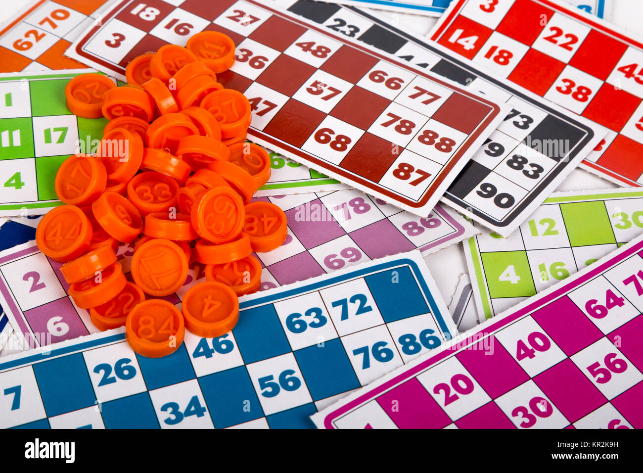 Colorful lotto or bingo game papers with numbers and plastic lotto ...